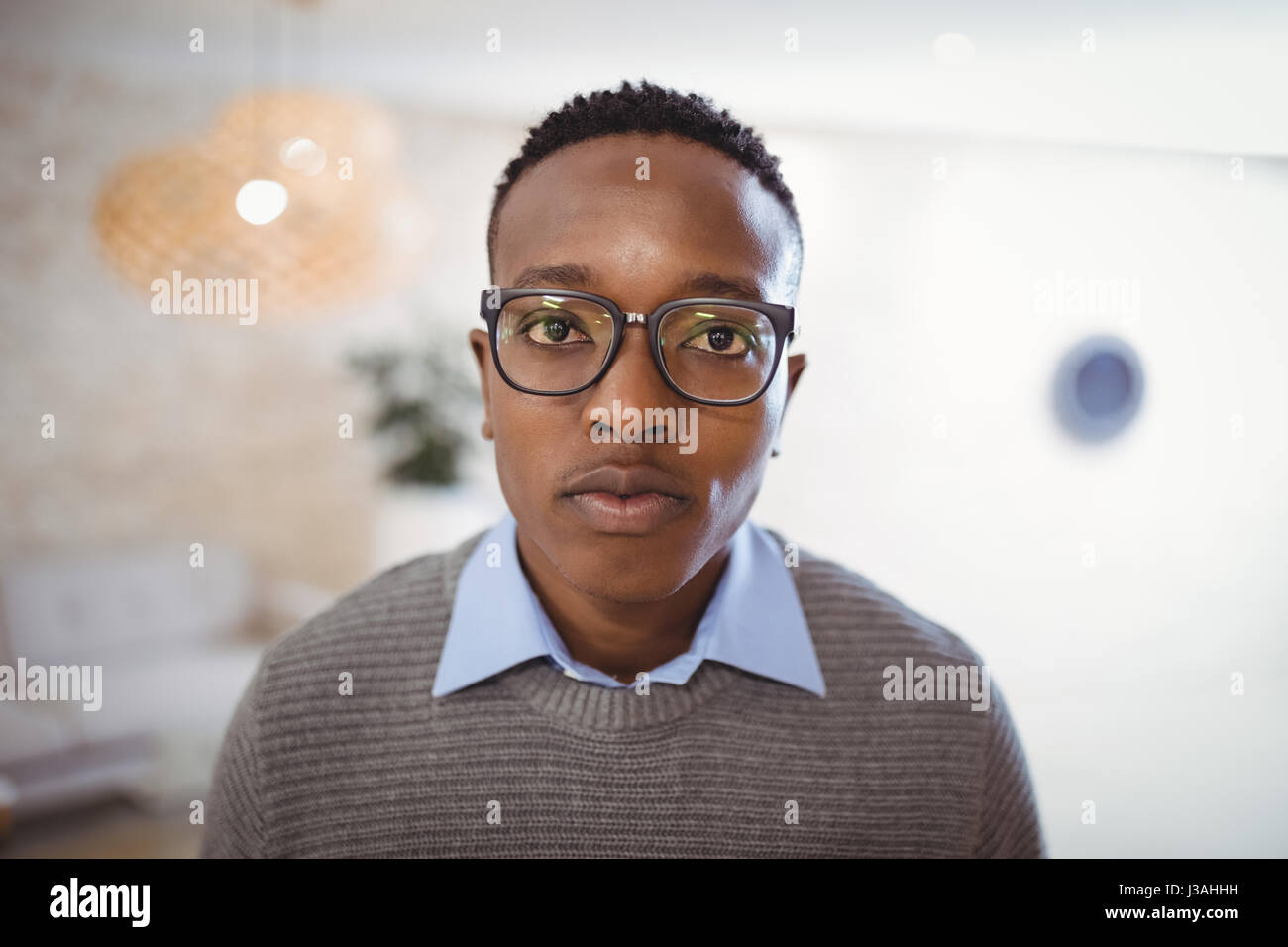 Close-up of executive wearing spectacles in office Stock Photo - Alamy