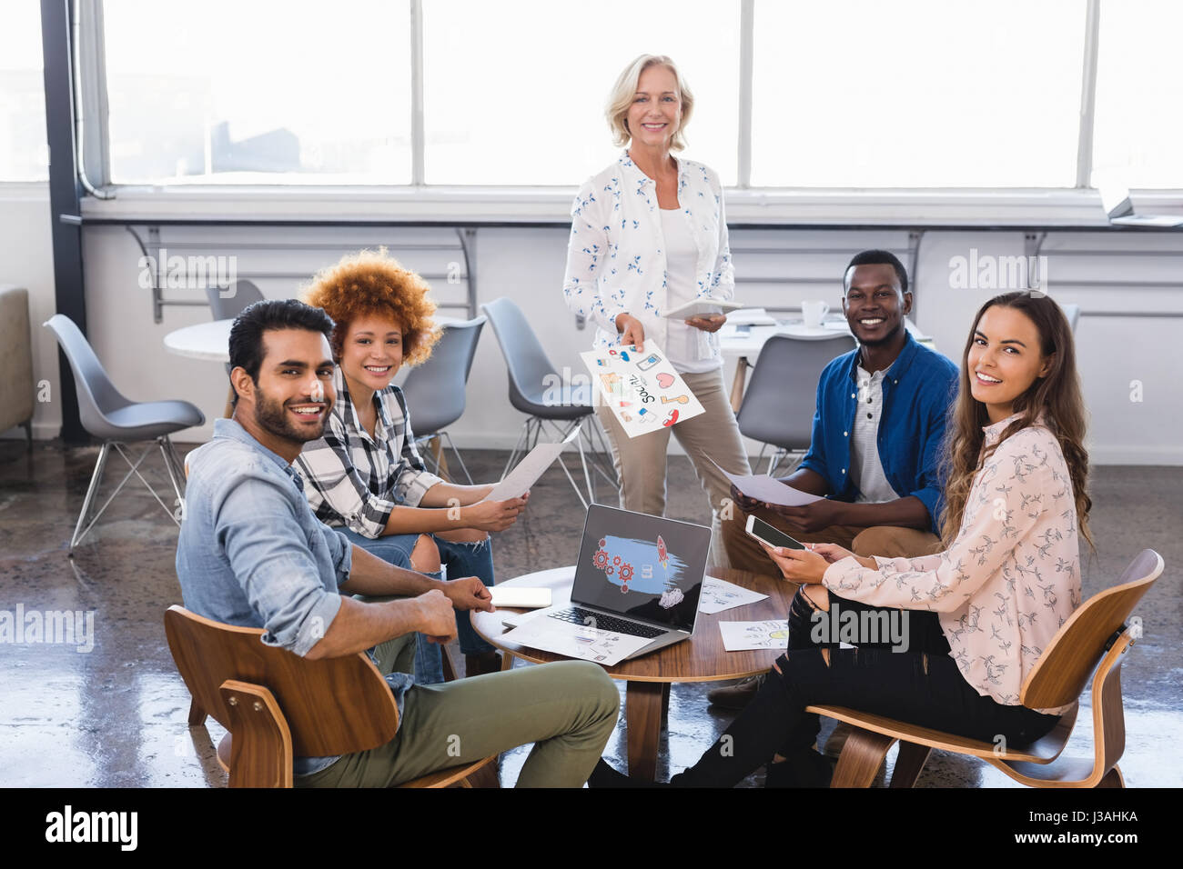 Portrait happy young business team working together at creative office ...