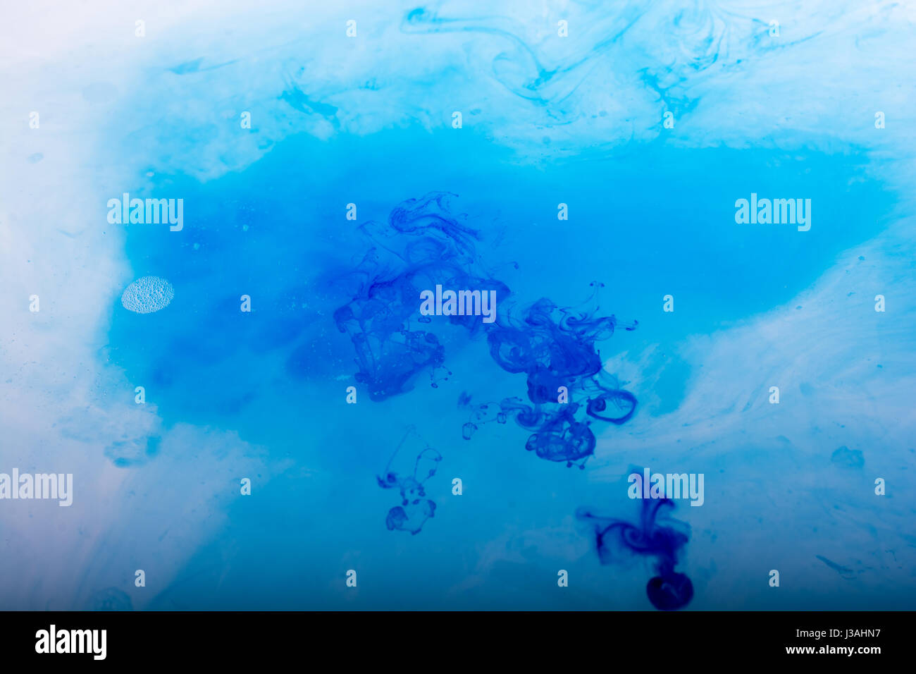 Watercolor paint dissolving in pure water Stock Photo - Alamy