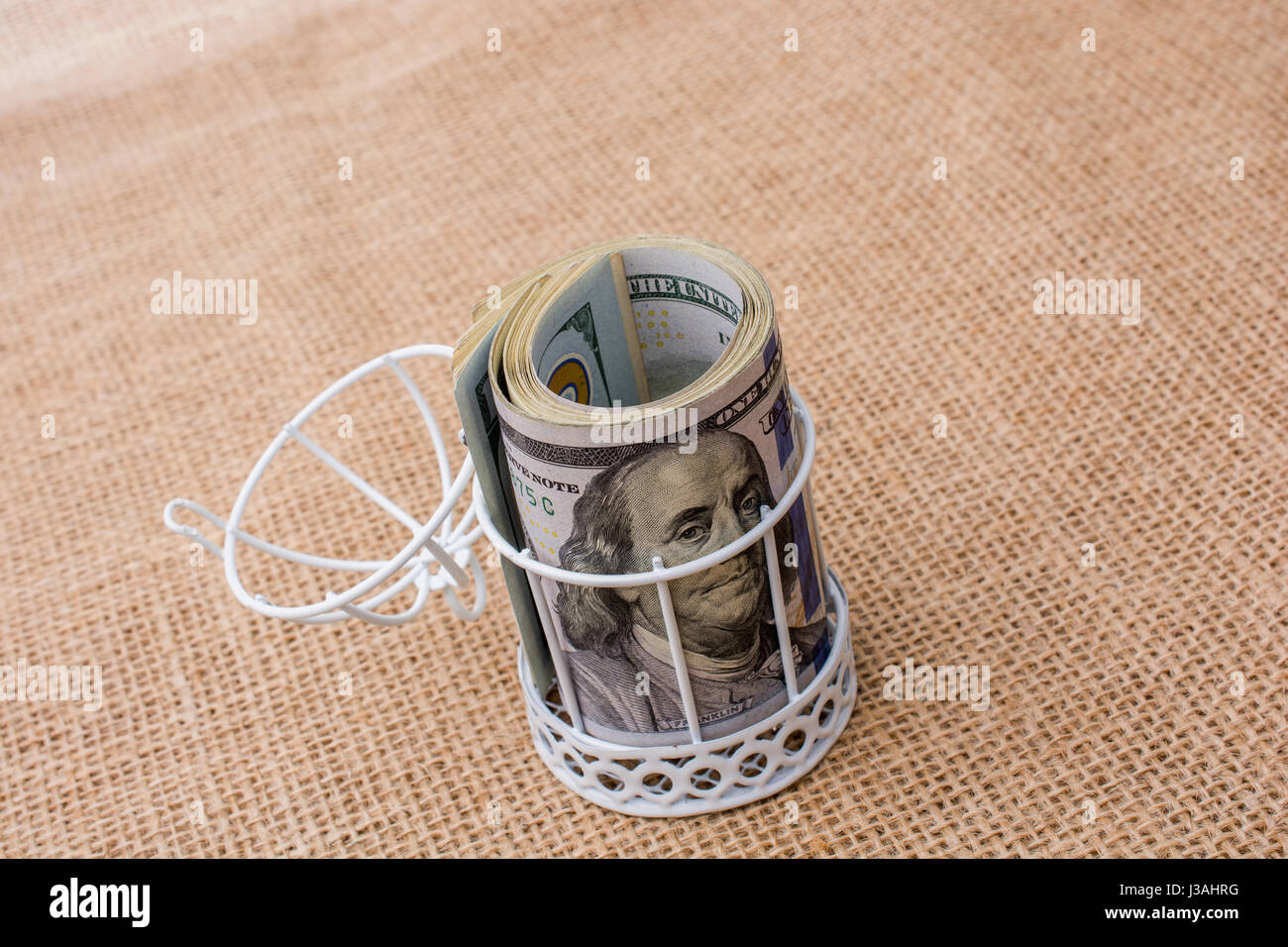 Banknote bundle of US dollar placed in a birds cage Stock Photo - Alamy