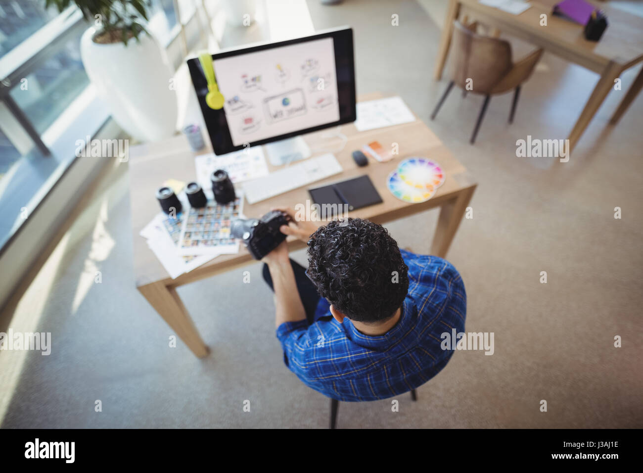 Overhead of graphic designer working at desk in office Stock Photo - Alamy
