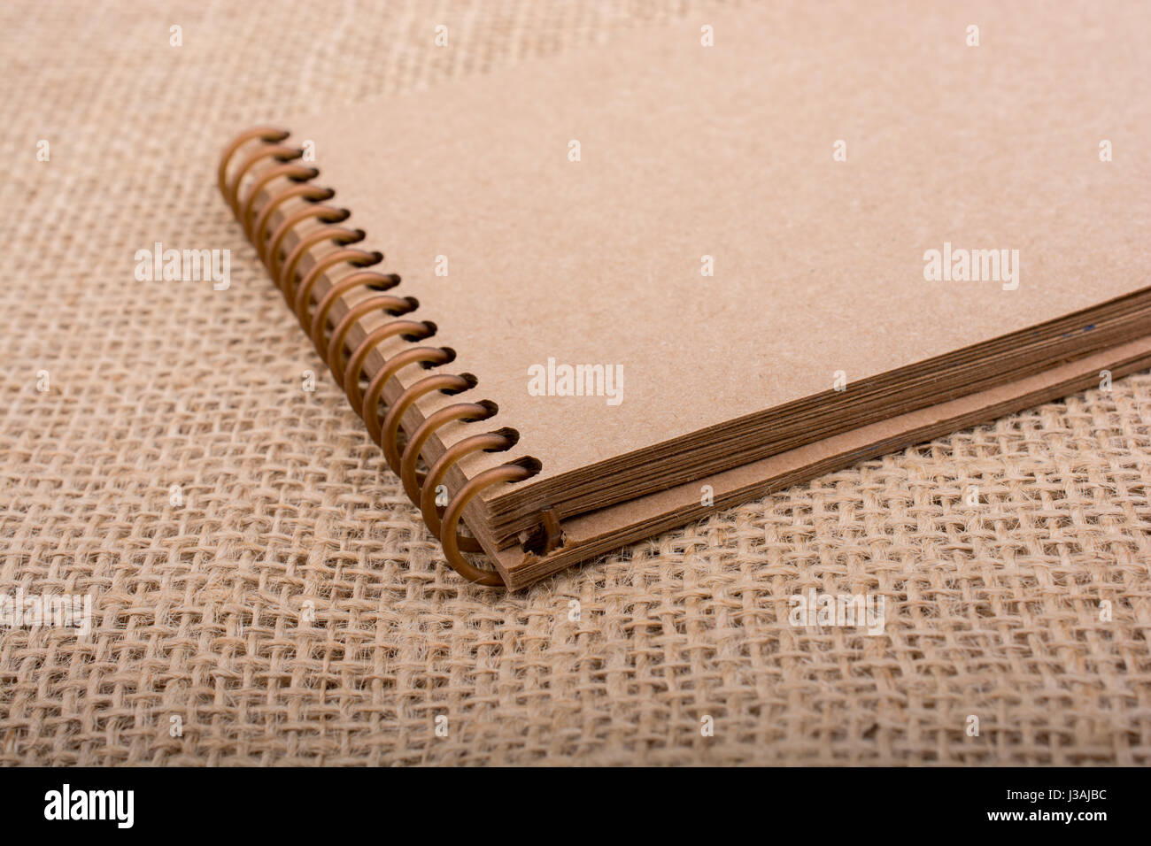 brown color notebook placed on a canvas background Stock Photo - Alamy