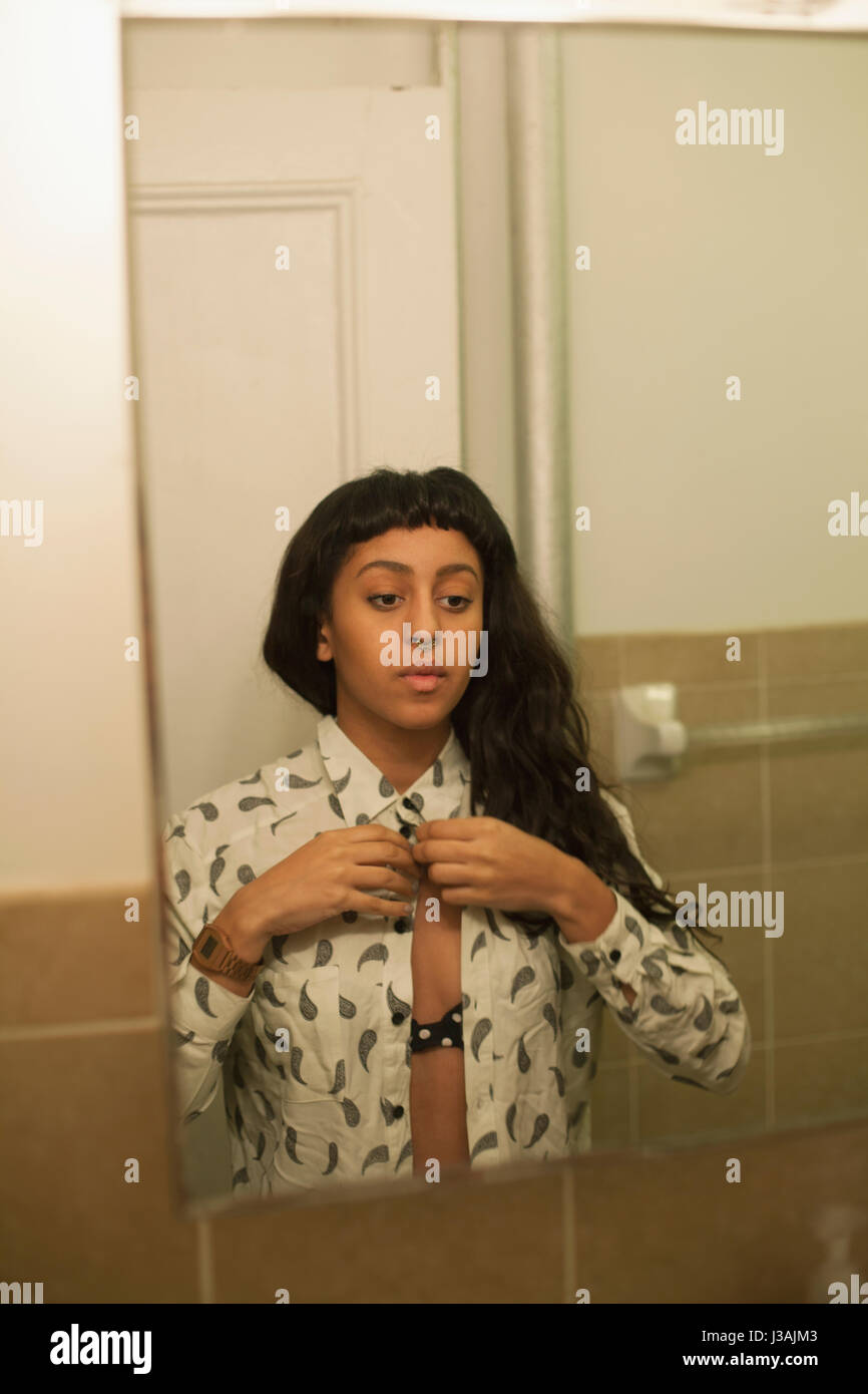 Young woman getting dressed Stock Photo - Alamy