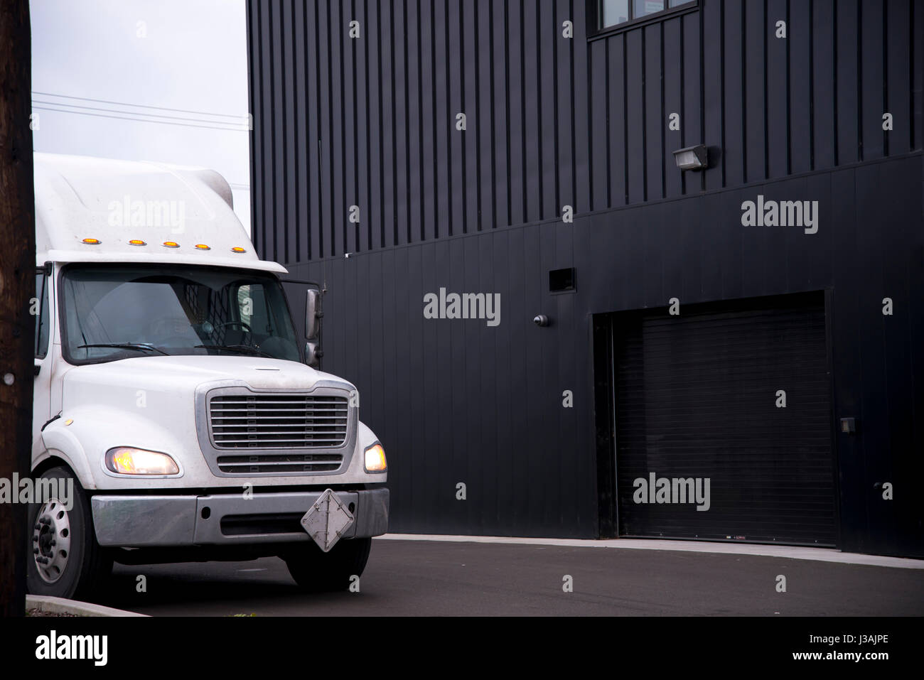 White middle-class semi truck day cab with trailer for transport of ...