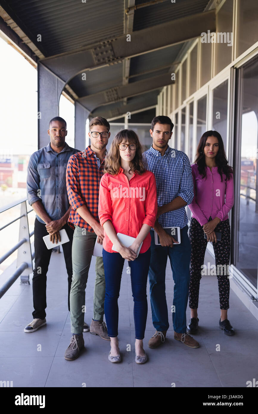 Full length portrait of business people standing in balcony Stock Photo ...