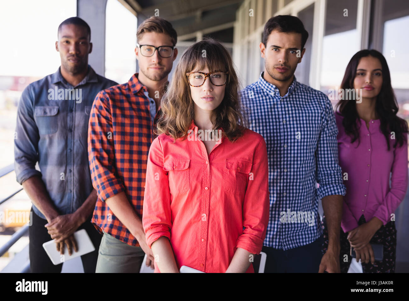 Portrait of confident business people standing in balcony Stock Photo ...