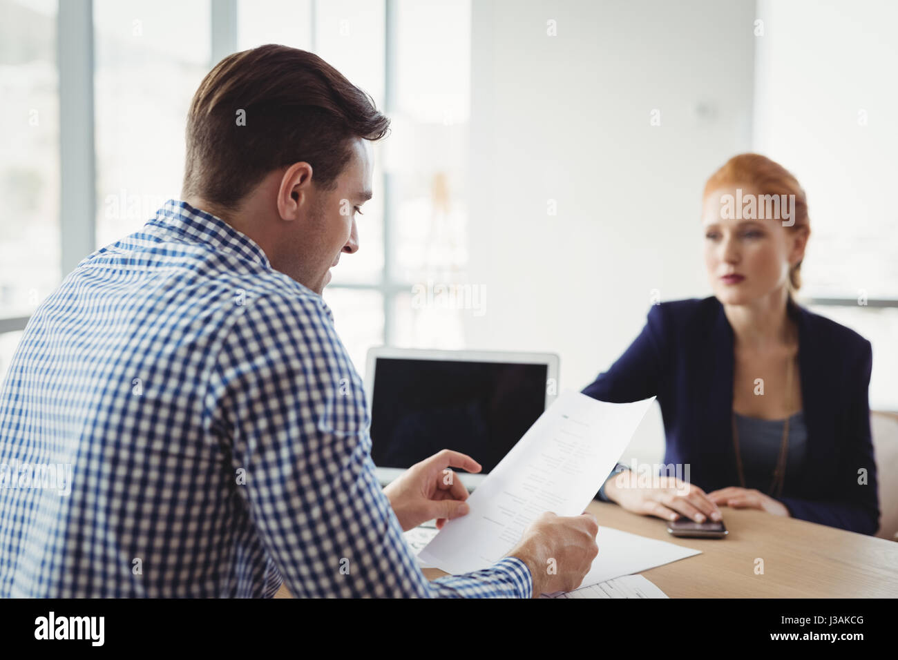 Executive reading document at desk in office Stock Photo - Alamy