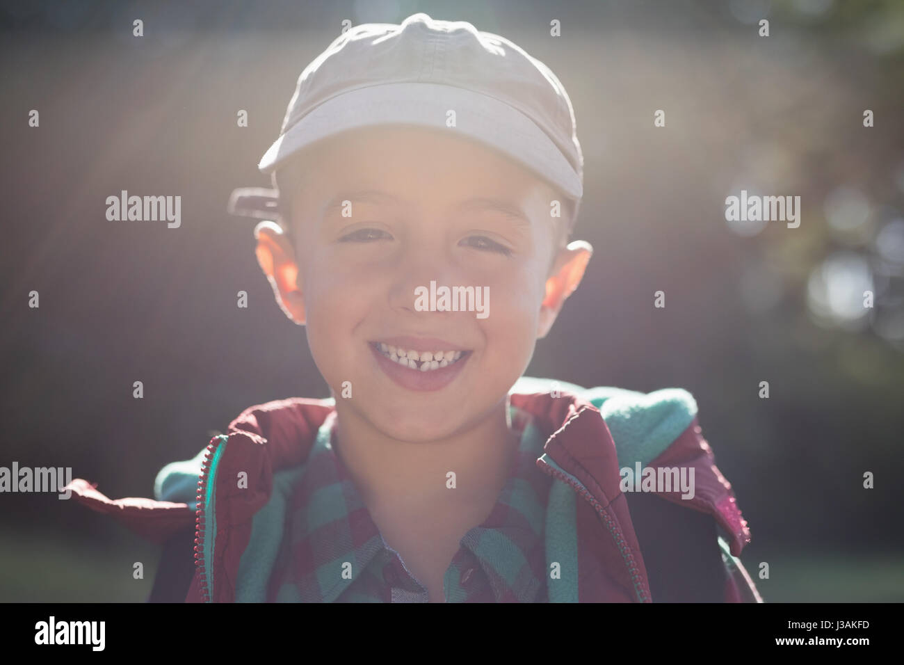 Close-up portrait happy boy standing in forest Stock Photo - Alamy