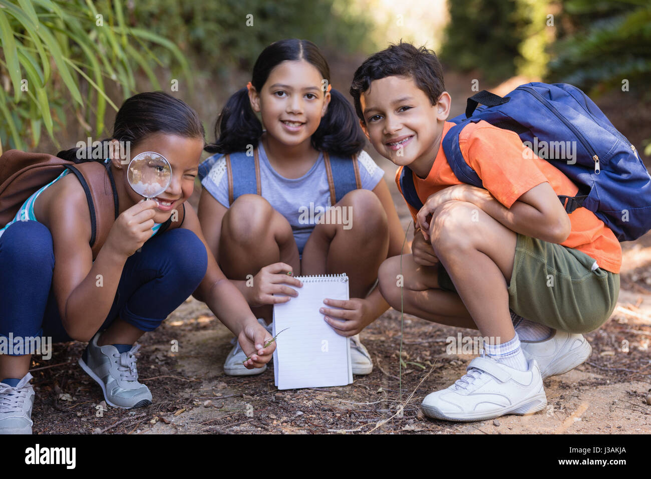 Portrait of smiling friends exploring nature at natural parkland Stock ...