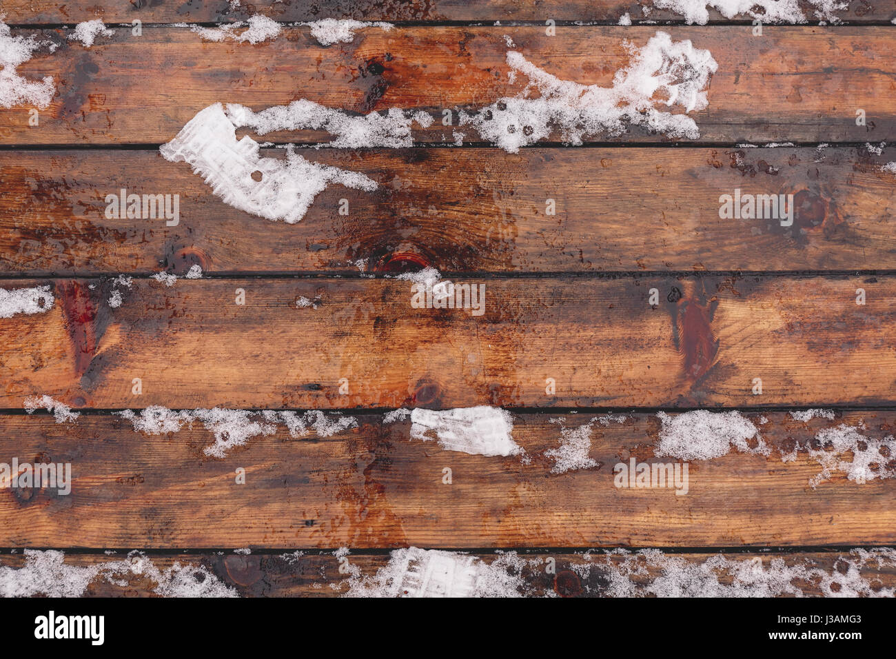 Winter background with wooden floor covered by snow and footprint on it ...