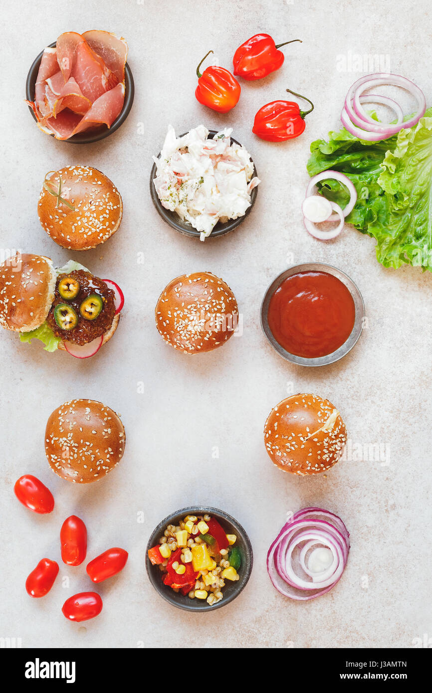 Preparing homemade burgers, various fillings on rustic surface. Top ...