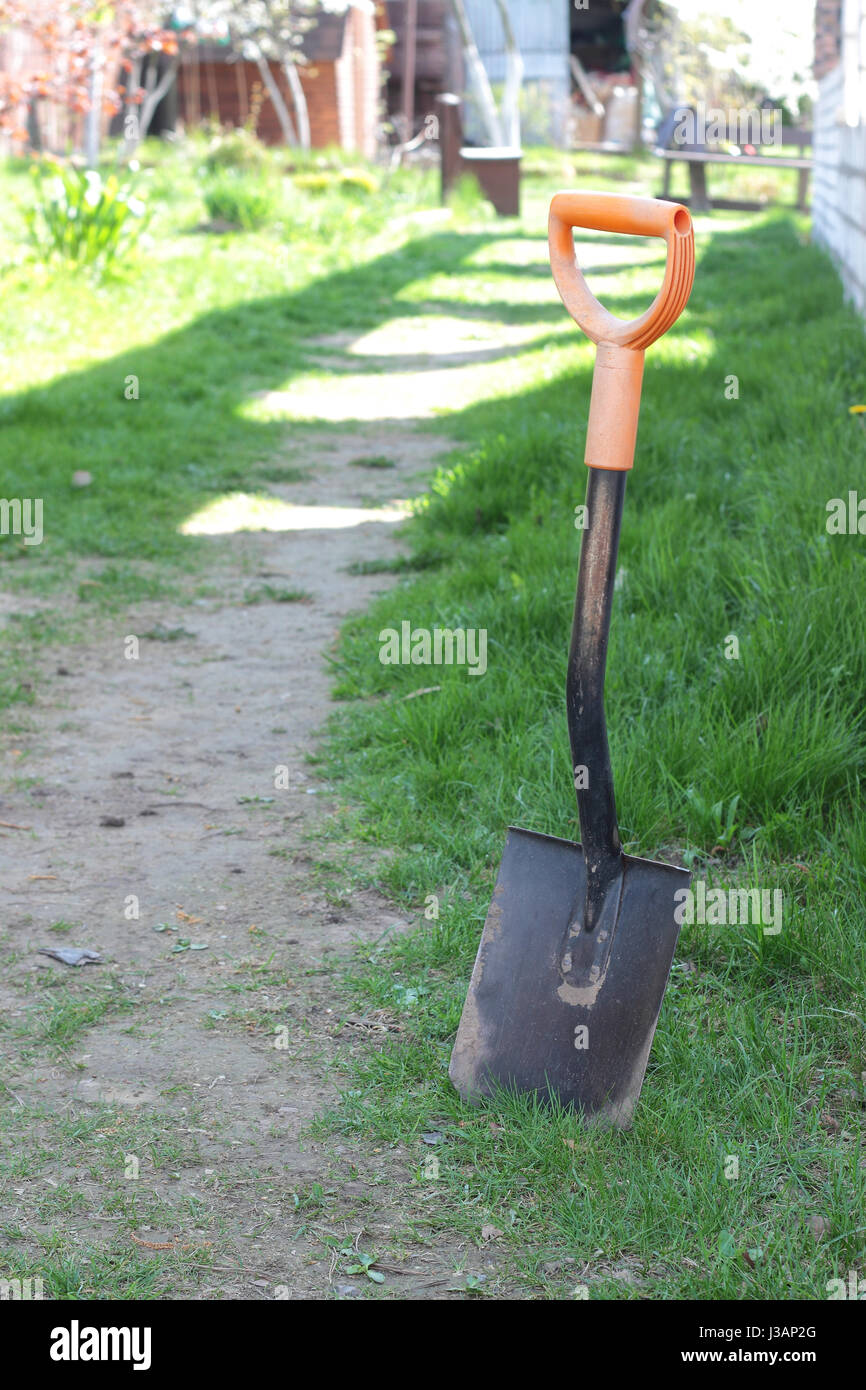 Garden - Shovel is sticks to the grass soil Stock Photo - Alamy