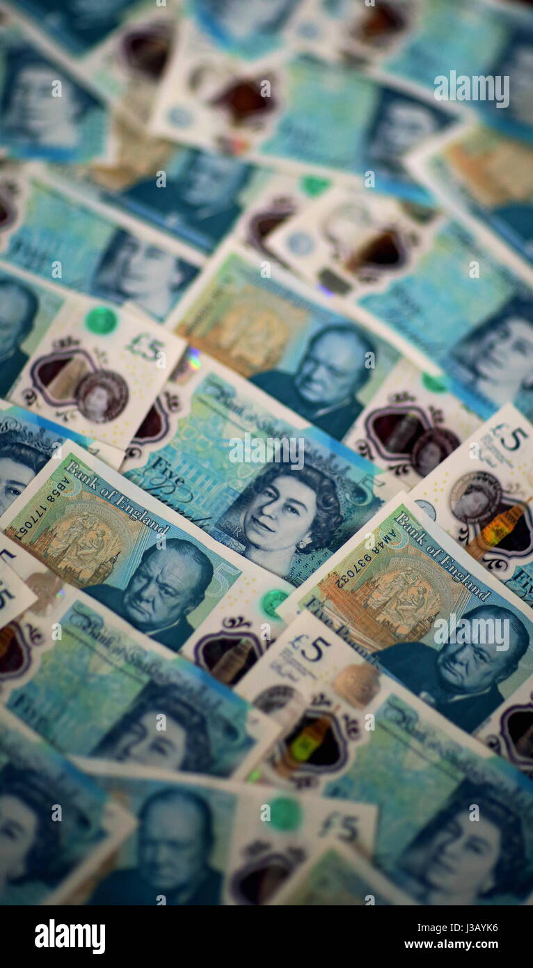 Swansea, UK. 4th May, 2017. A layer of new £5 notes. The £5 banknote ...