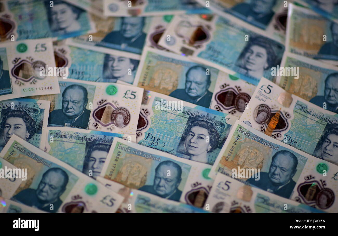 Swansea, UK. 4th May, 2017. A layer of new £5 notes. The £5 banknote ...