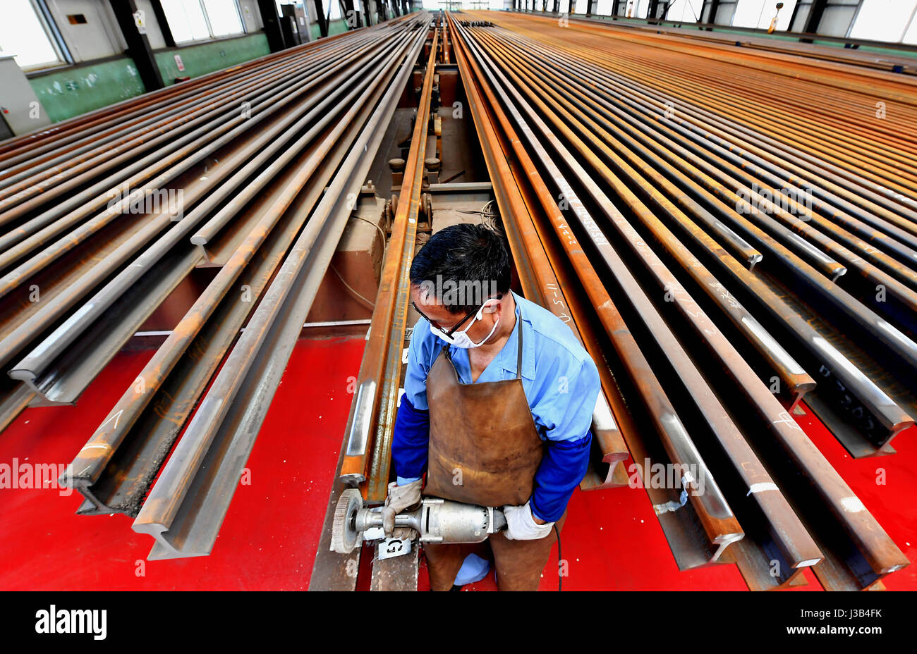 Zhengzhou, China's Henan Province. 4th May, 2017. A welder derusts ...