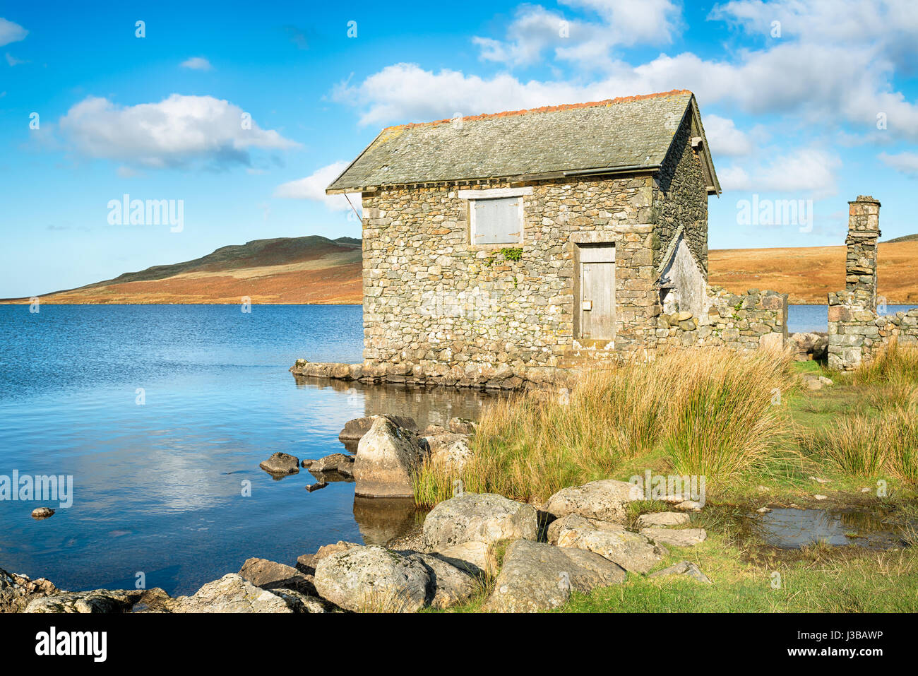 The ruins of an ancient stone boathouse at Devoke Water in the Lake ...