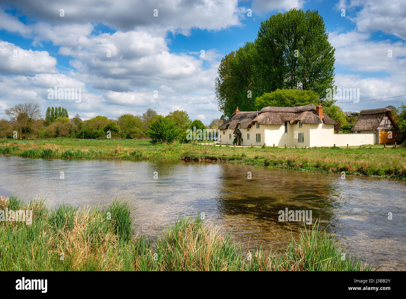 Thatched cottage on the banks of the river Test at Chilbolton Cow ...