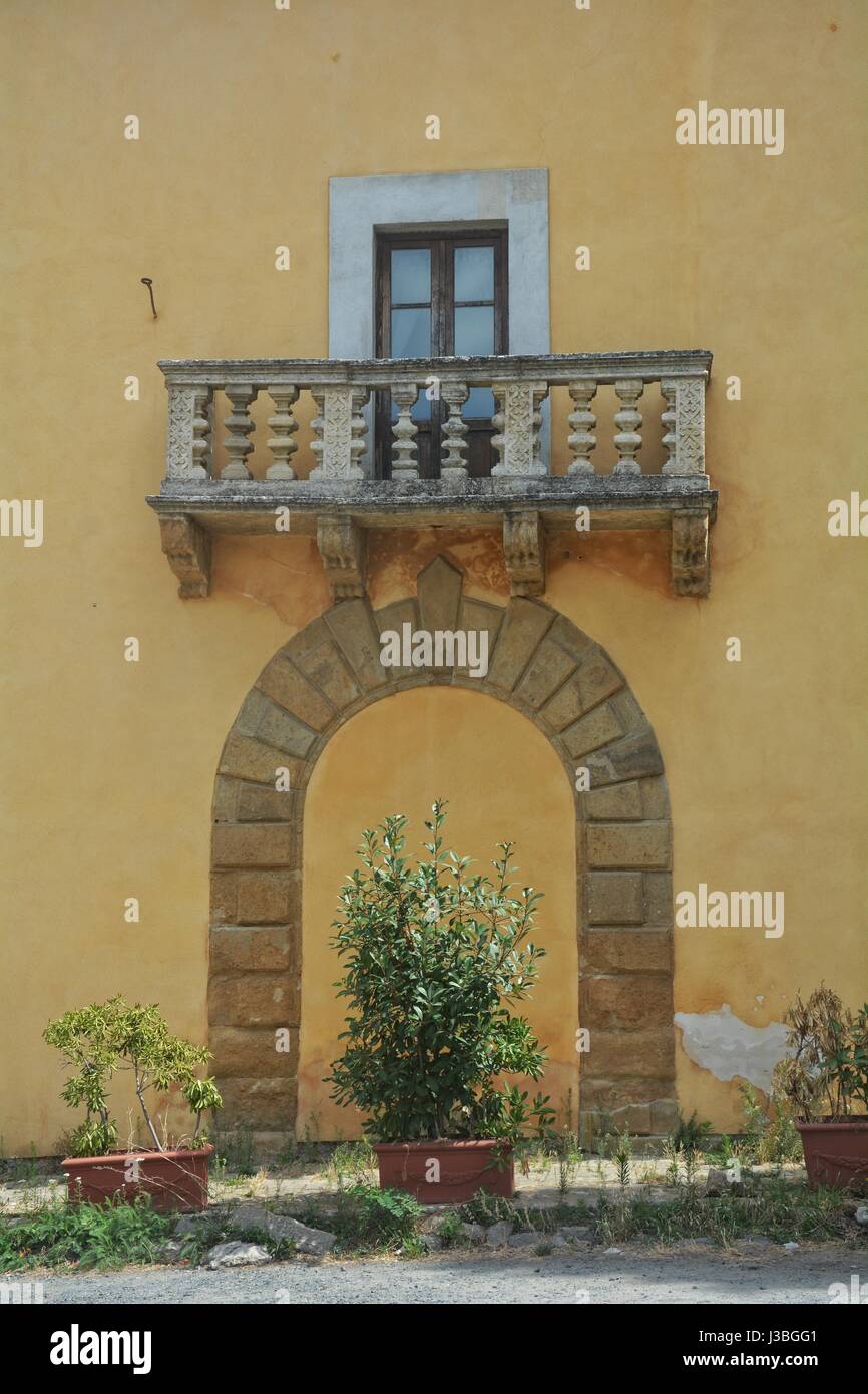 Old balcony of stone in a yellow house in Tuscany, Italy Stock Photo ...