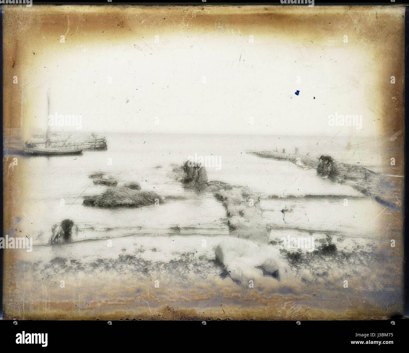 This image features a glass plate photograph taken during a historic ...