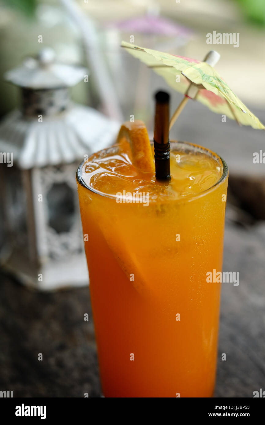 Alcoholic Gin and Juice Cocktail with ice cube, fresh Orange and ...