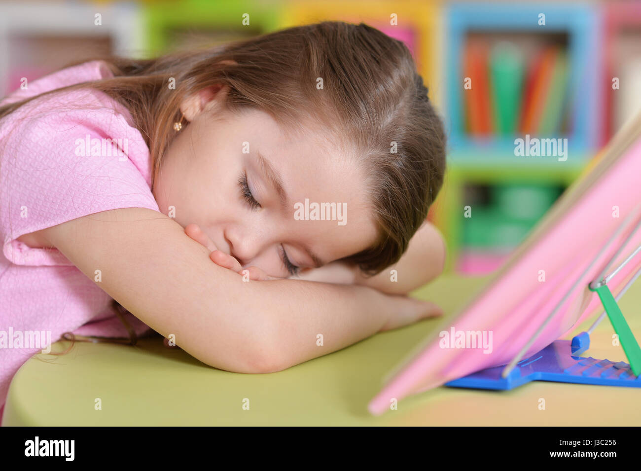 Little girl fell asleep at the table Stock Photo - Alamy