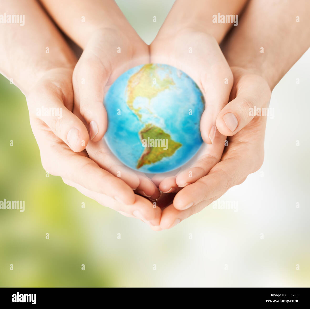 woman and man hands holding earth planet Stock Photo - Alamy