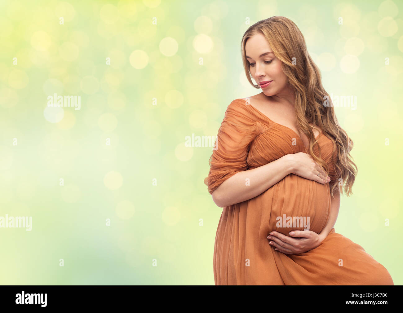 happy pregnant woman touching her big belly Stock Photo - Alamy