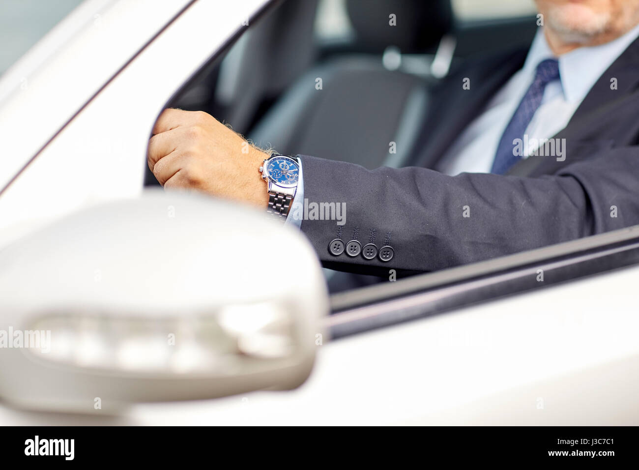 senior businessman hands driving car Stock Photo - Alamy