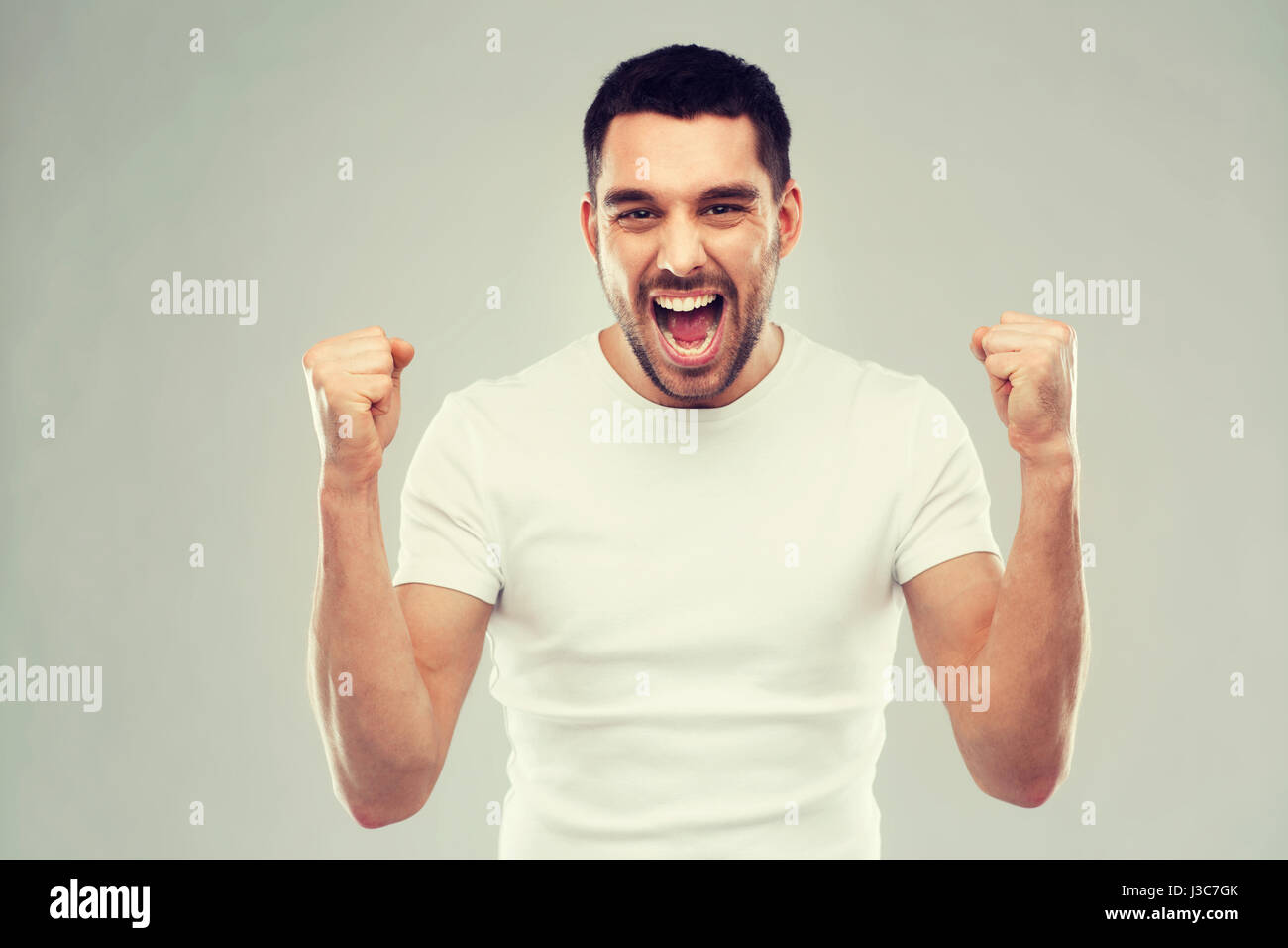 Happy man celebrating success achievement hi-res stock photography and ...