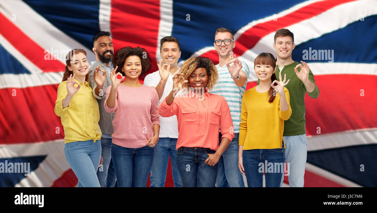 international people showing ok over british flag Stock Photo - Alamy