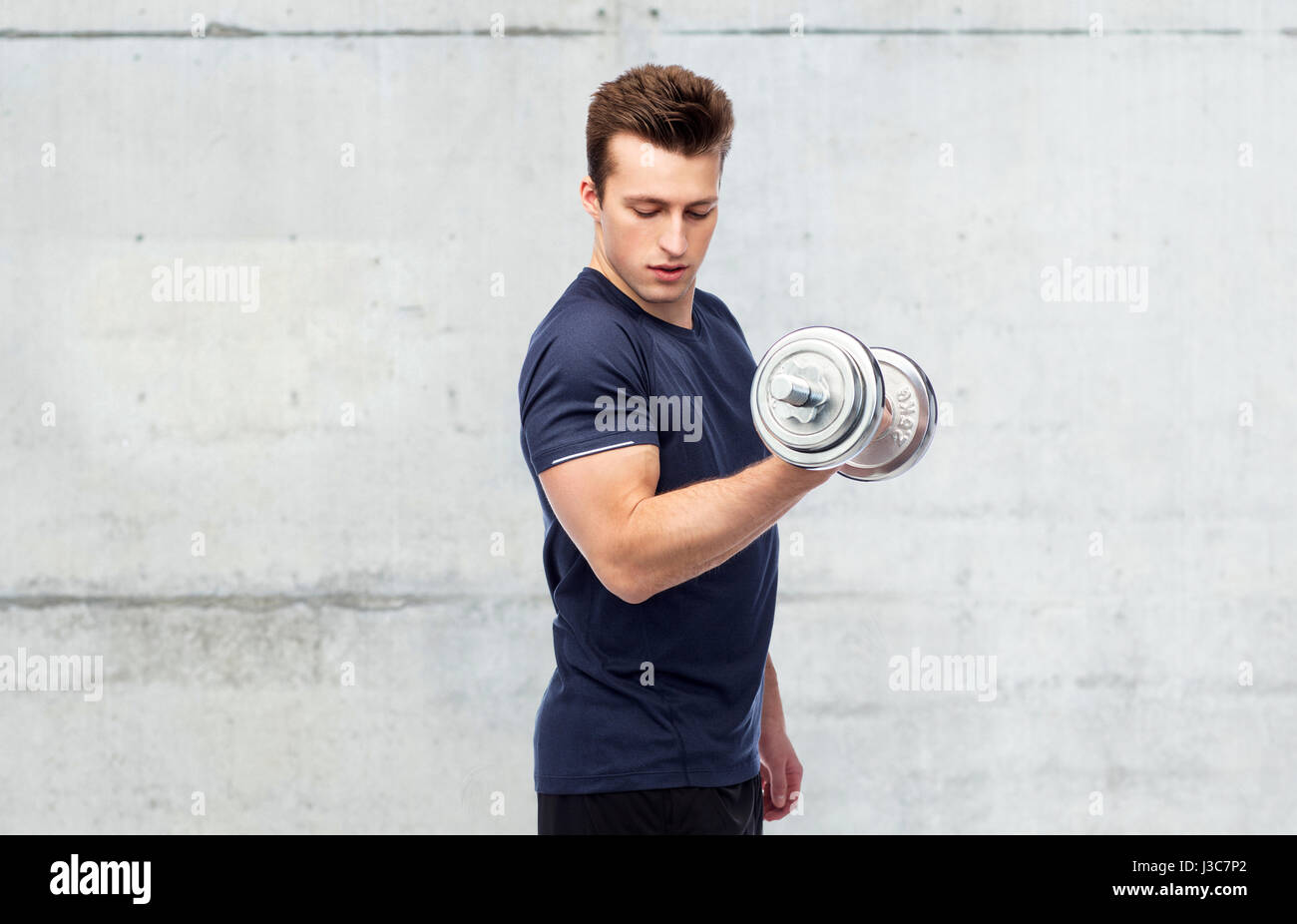 sportive man flexing muscles with dumbbell Stock Photo - Alamy