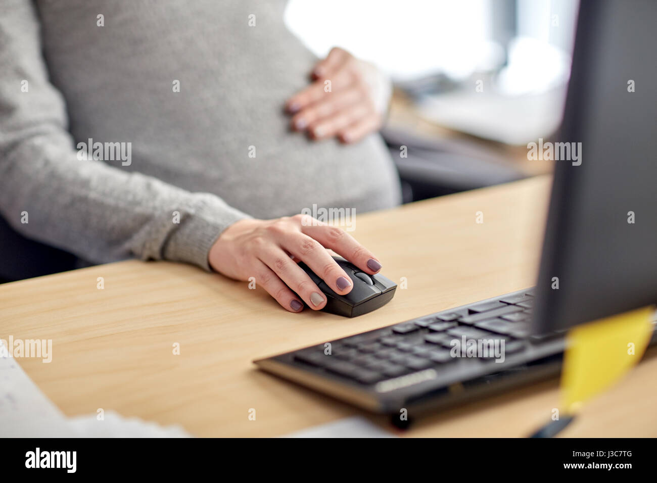 pregnant businesswoman with computer at office Stock Photo - Alamy