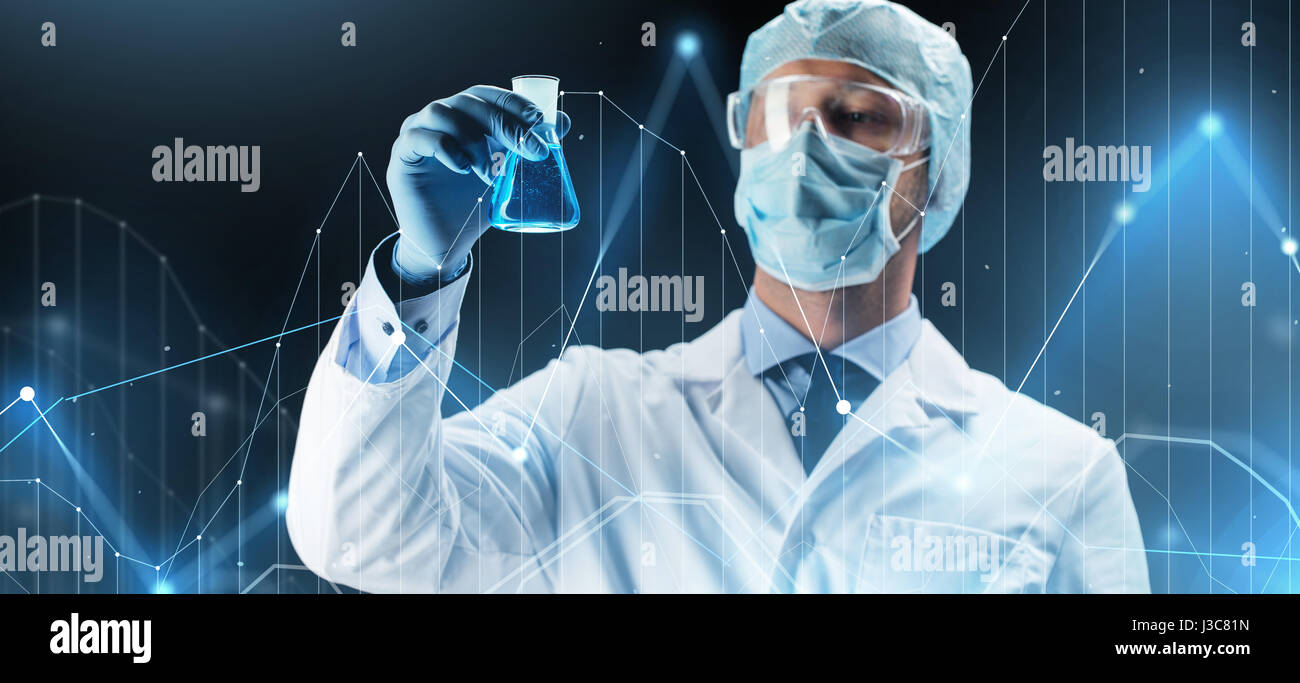 scientist in mask holding flask with chemical Stock Photo - Alamy