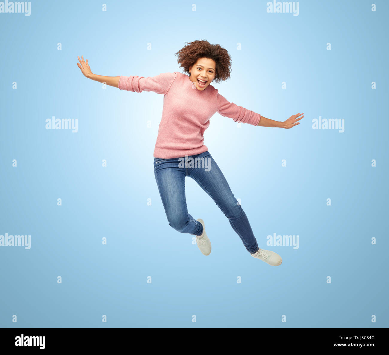 happy african american woman jumping over white Stock Photo - Alamy