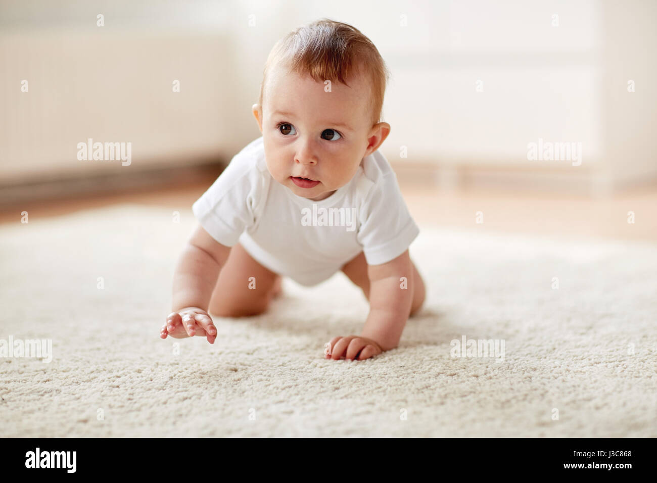 little baby in diaper crawling on floor at home Stock Photo - Alamy