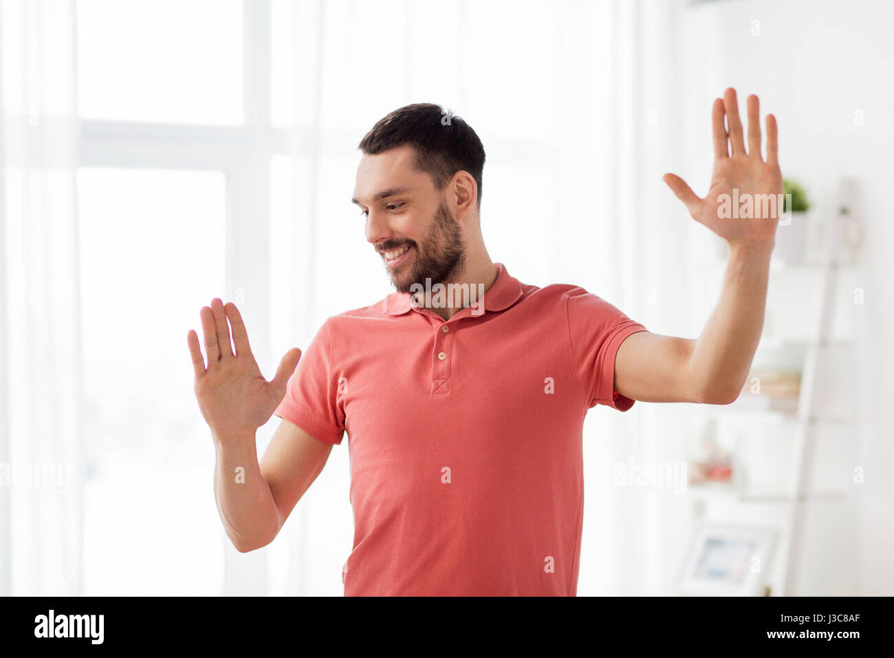 happy man touching something imaginary at home Stock Photo - Alamy