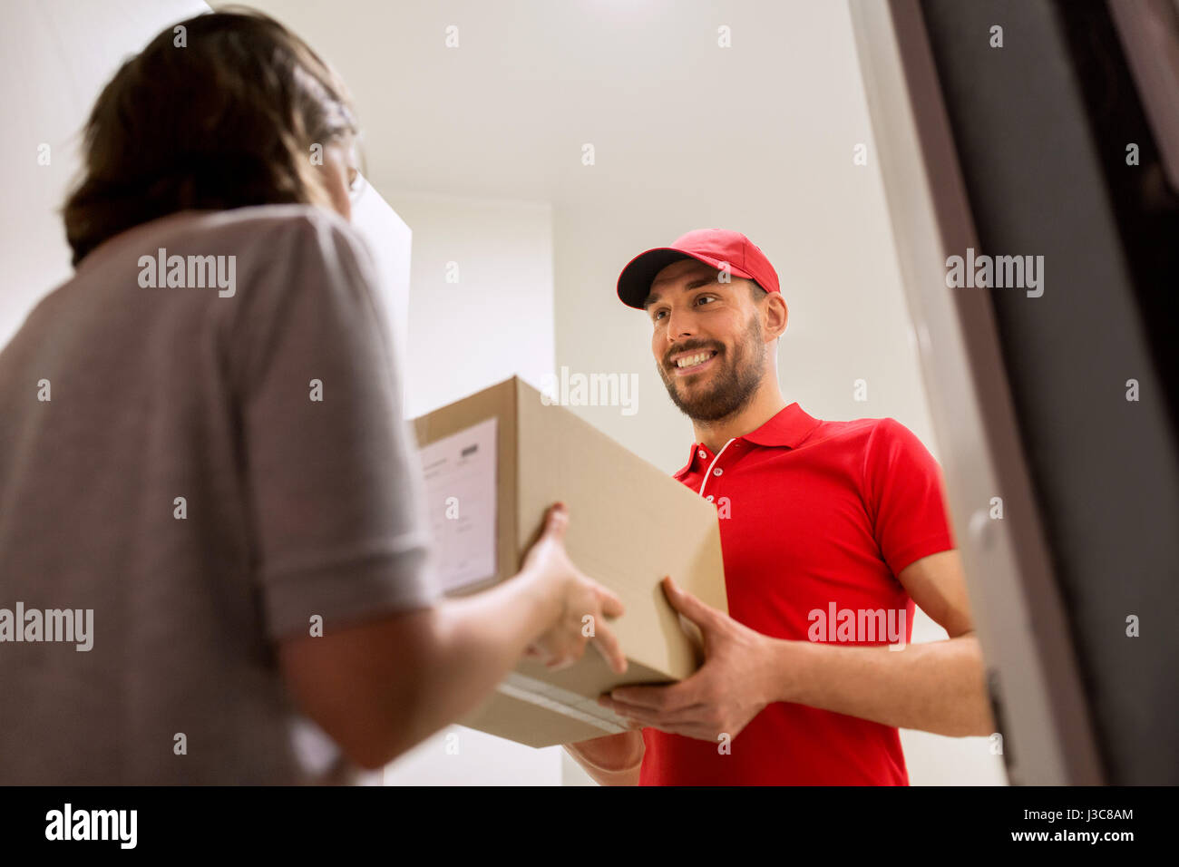 happy delivery man giving parcel box to customer Stock Photo - Alamy