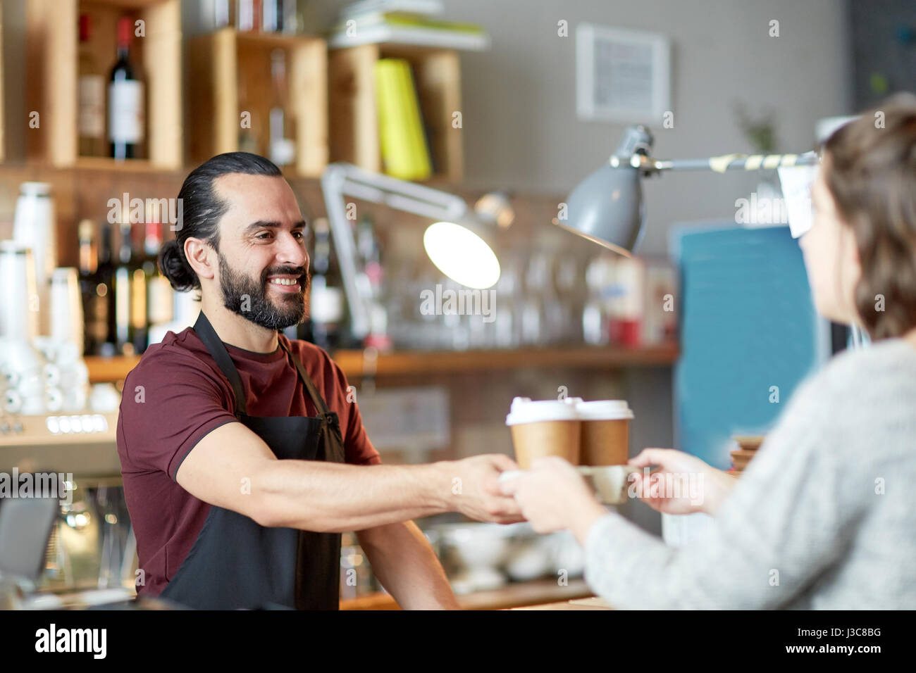 man or waiter serving customer in coffee shop Stock Photo - Alamy