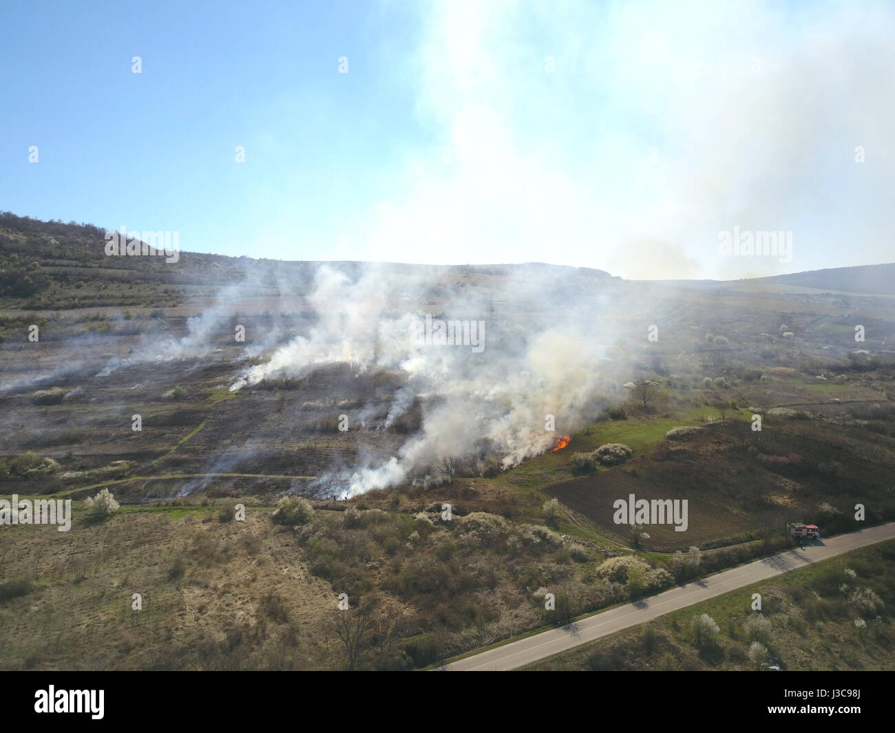 Fire burns in the forest above a village of Bozveliisko, some 60 km ...