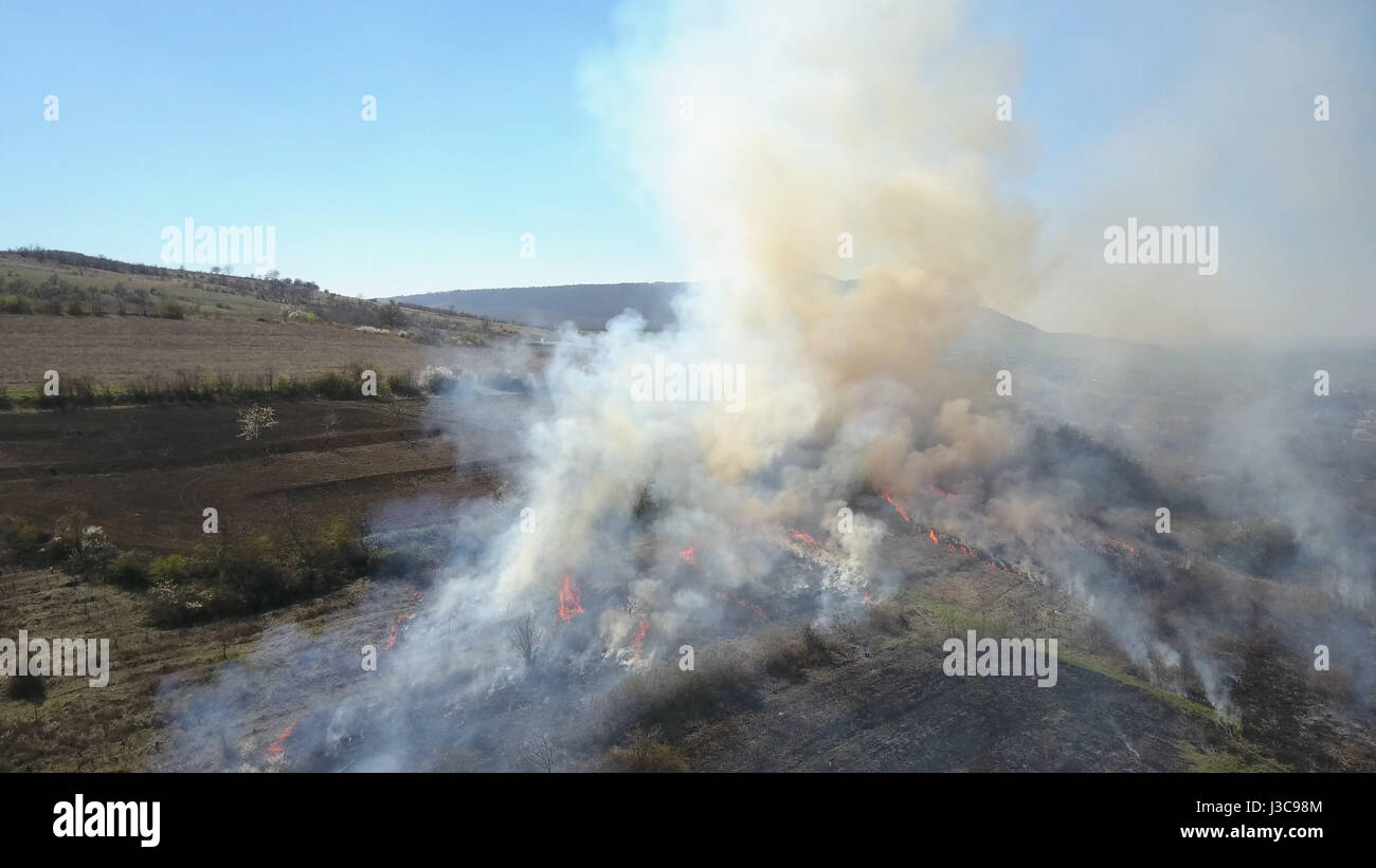 Fire burns in the forest above a village of Bozveliisko, some 60 km ...