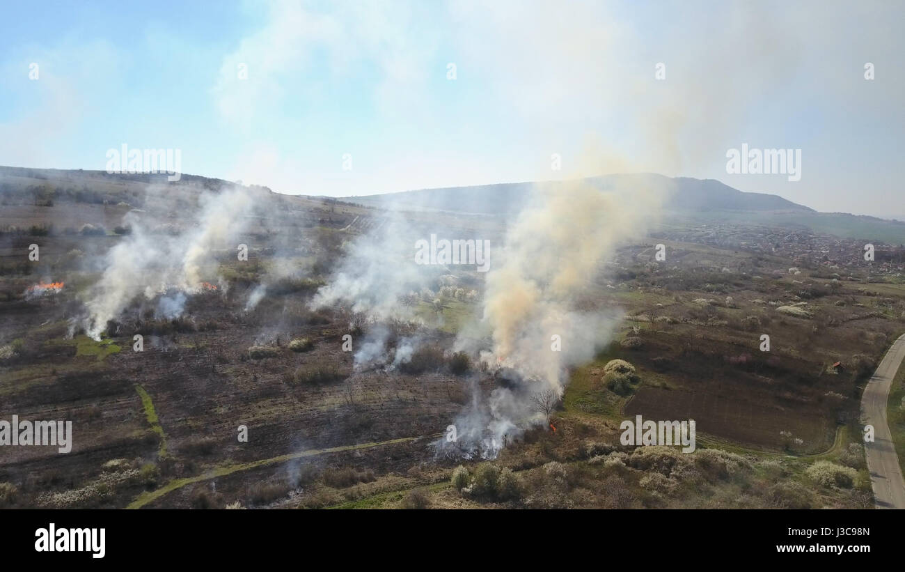 Fire burns in the forest above a village of Bozveliisko, some 60 km ...