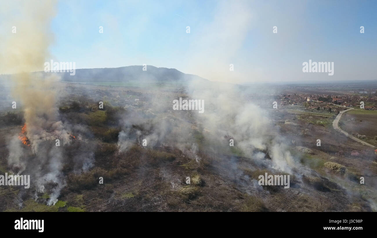Fire burns in the forest above a village of Bozveliisko, some 60 km ...