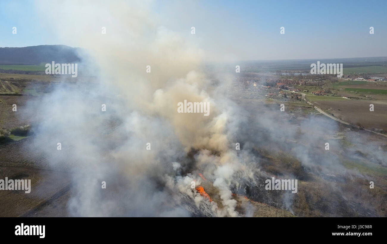 Fire burns in the forest above a village of Bozveliisko, some 60 km ...