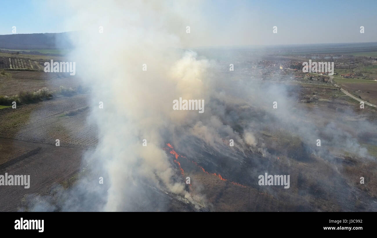 Fire burns in the forest above a village of Bozveliisko, some 60 km ...