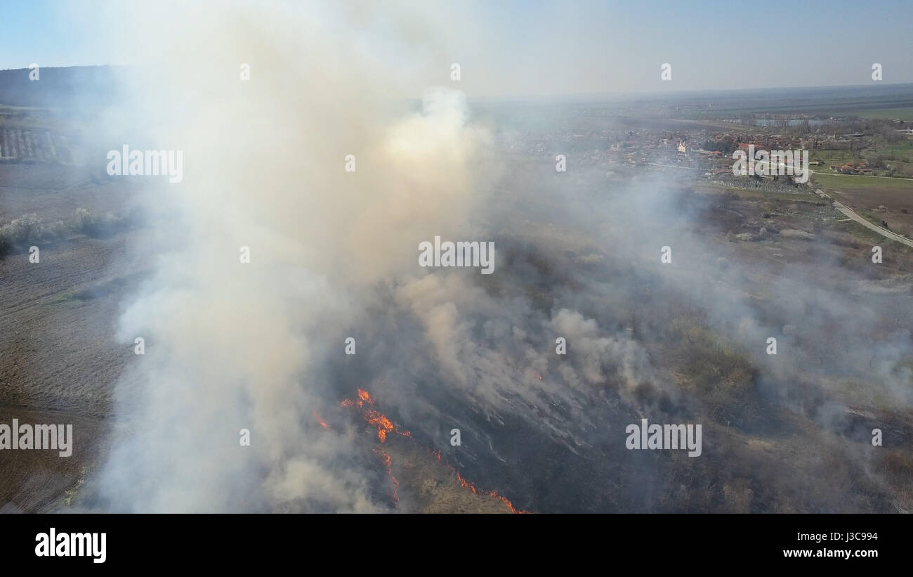 Fire burns in the forest above a village of Bozveliisko, some 60 km ...