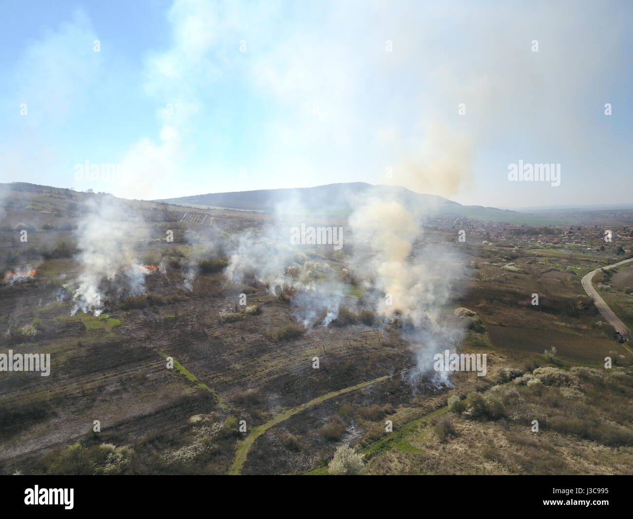 Fire burns in the forest above a village of Bozveliisko, some 60 km ...