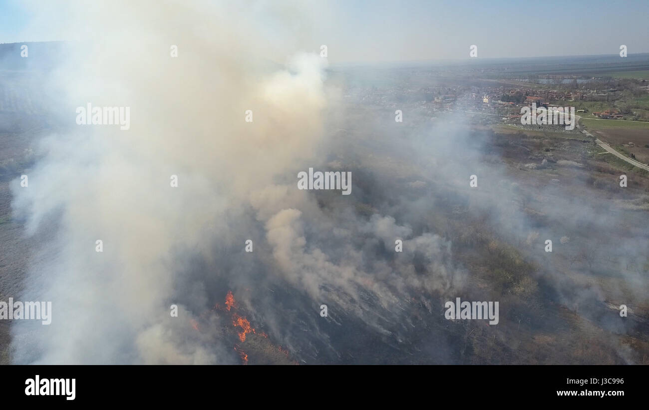 Fire burns in the forest above a village of Bozveliisko, some 60 km ...
