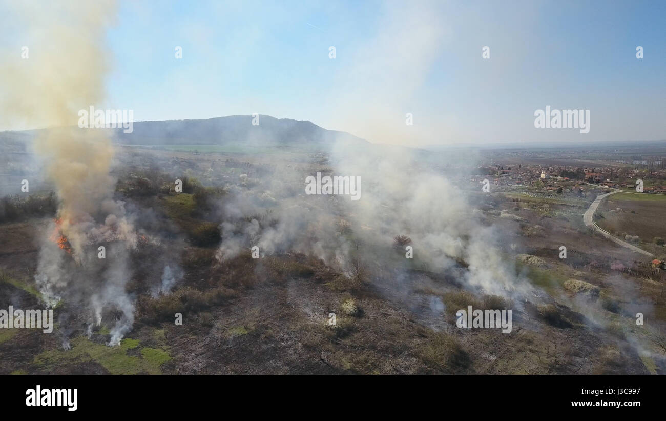 Fire burns in the forest above a village of Bozveliisko, some 60 km ...