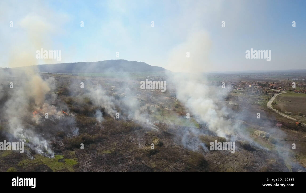 Fire burns in the forest above a village of Bozveliisko, some 60 km ...