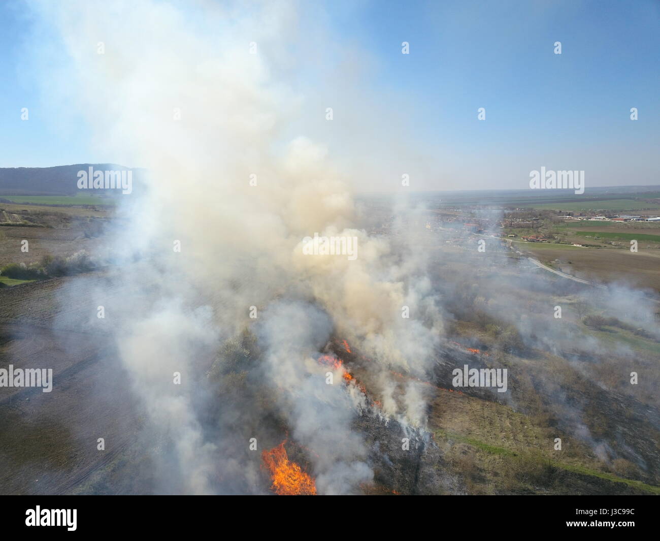Fire burns in the forest above a village of Bozveliisko, some 60 km ...